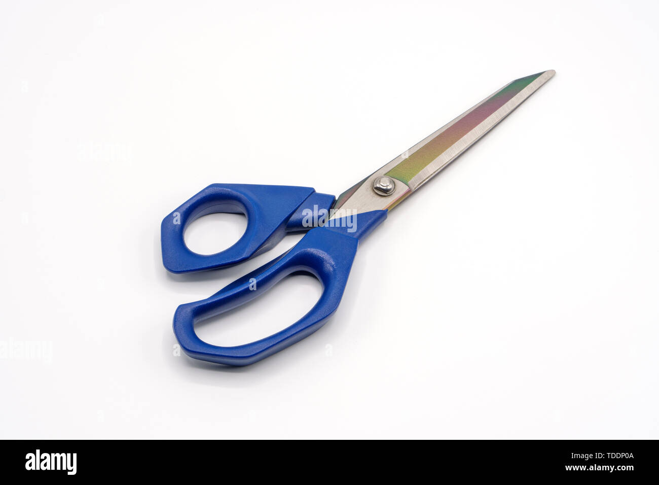 Metal tailor's scissors for sewing with blue large rings on a white ...