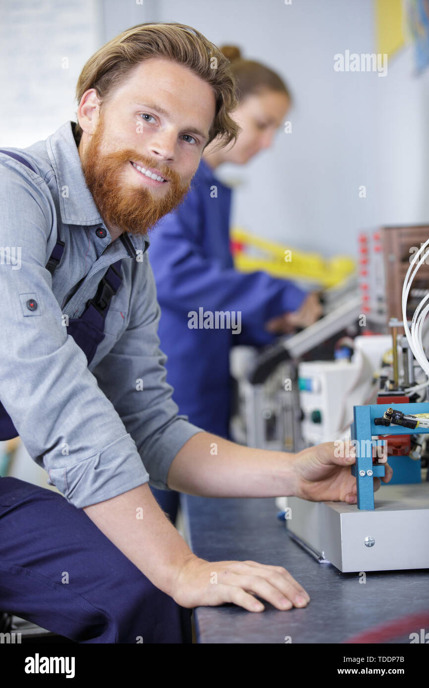 portrait of male operative working with factory equipment Stock Photo ...