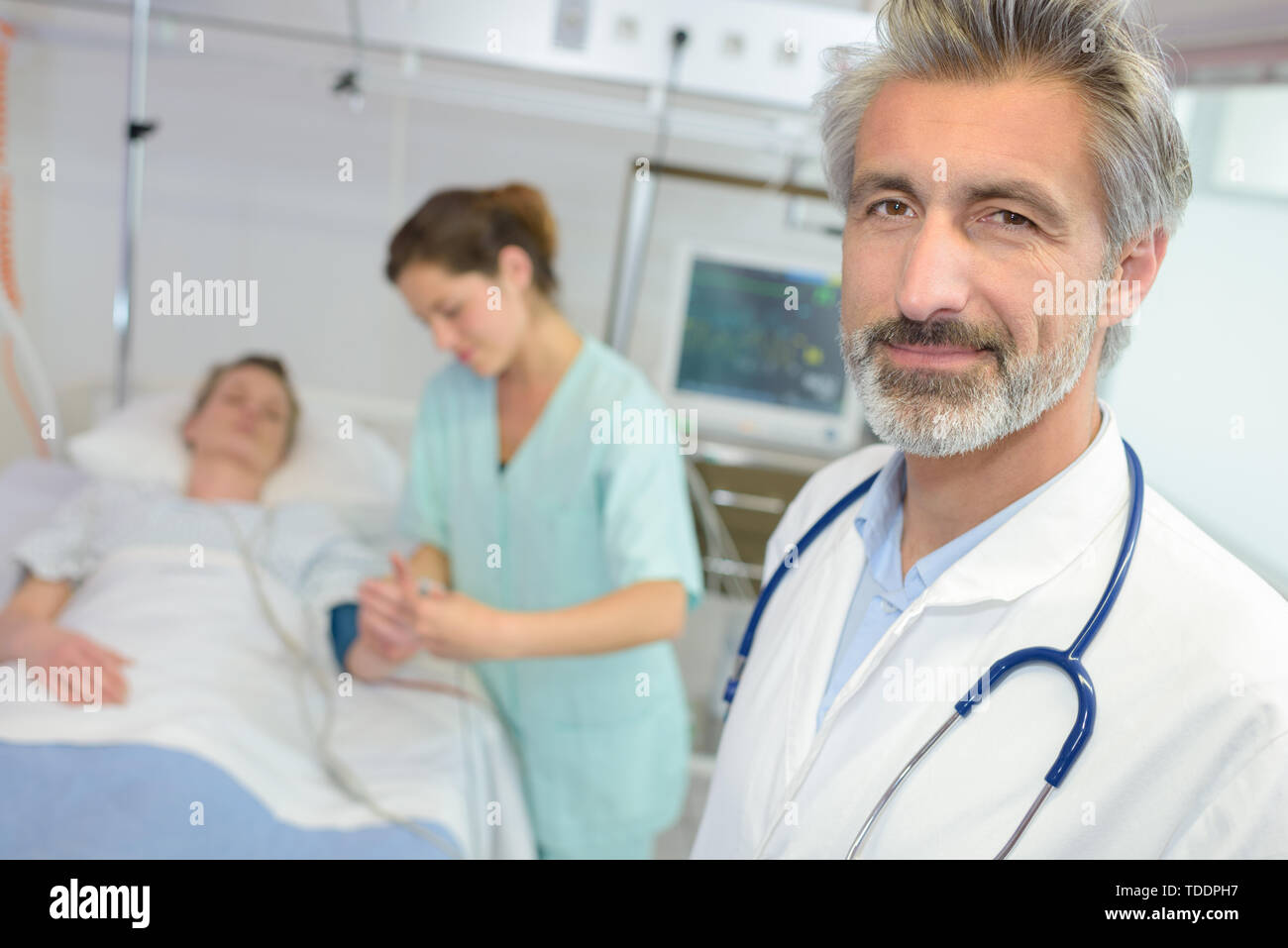 doctor at hospital bedroom with sick patient lying in bed Stock Photo ...