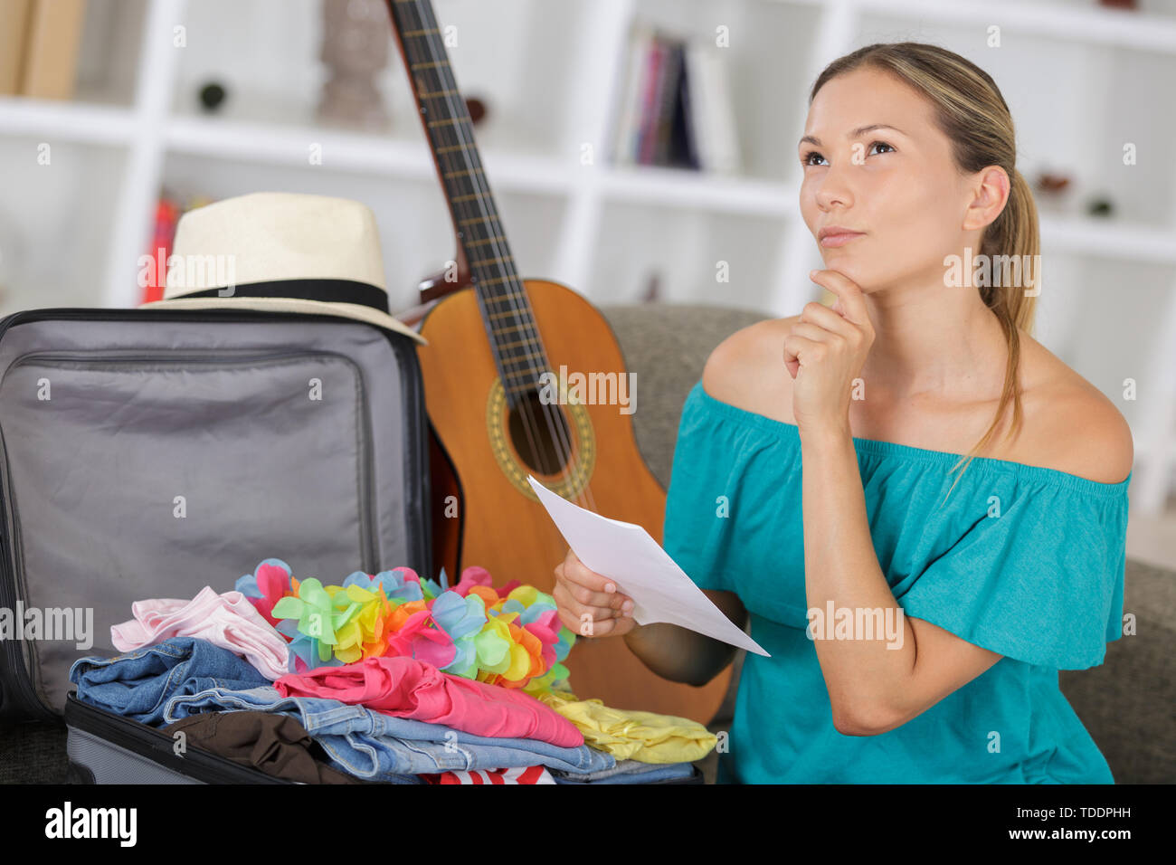woman holding her packing list Stock Photo - Alamy