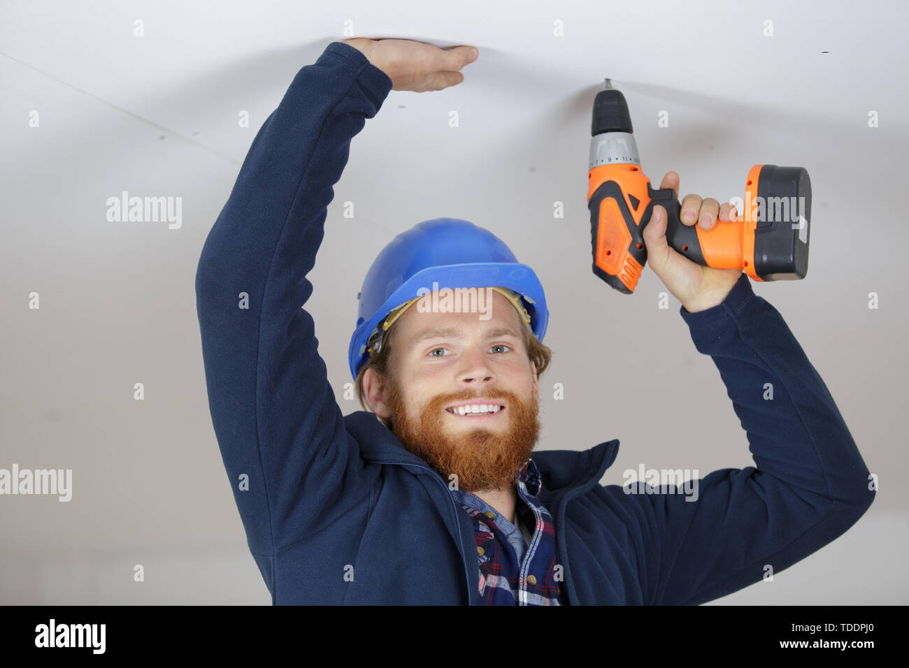 manual worker drilling ceiling with a drilling machine Stock Photo - Alamy