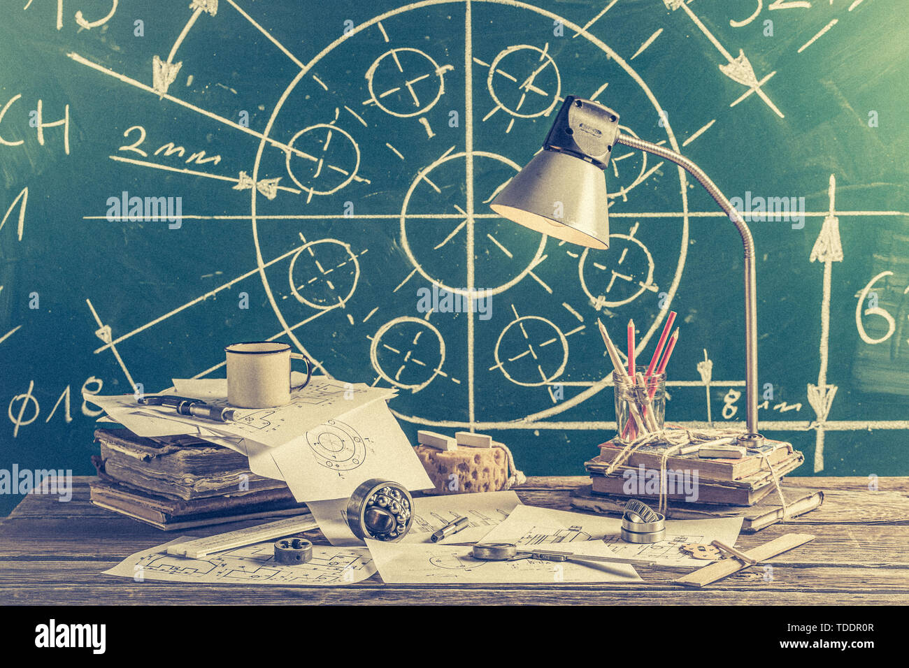 Mechanical engineer desk at the university on green blackboard ...