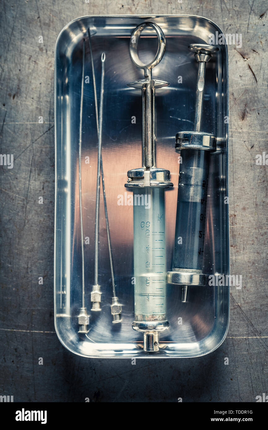 Syringes with needle in stainless steel container on metal table Stock ...