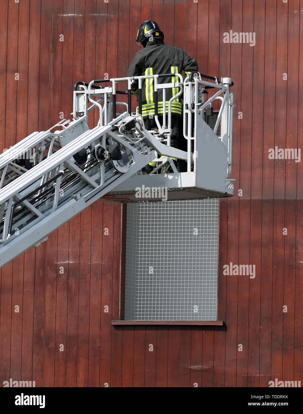Fireman on aerial ladder hi-res stock photography and images - Alamy