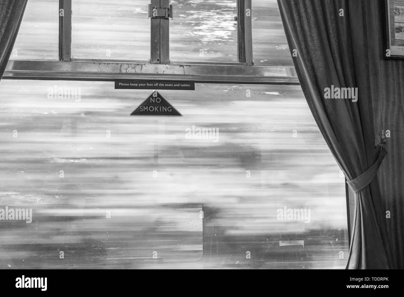 looking outside an old railway carriage window, at speed, black & white ...