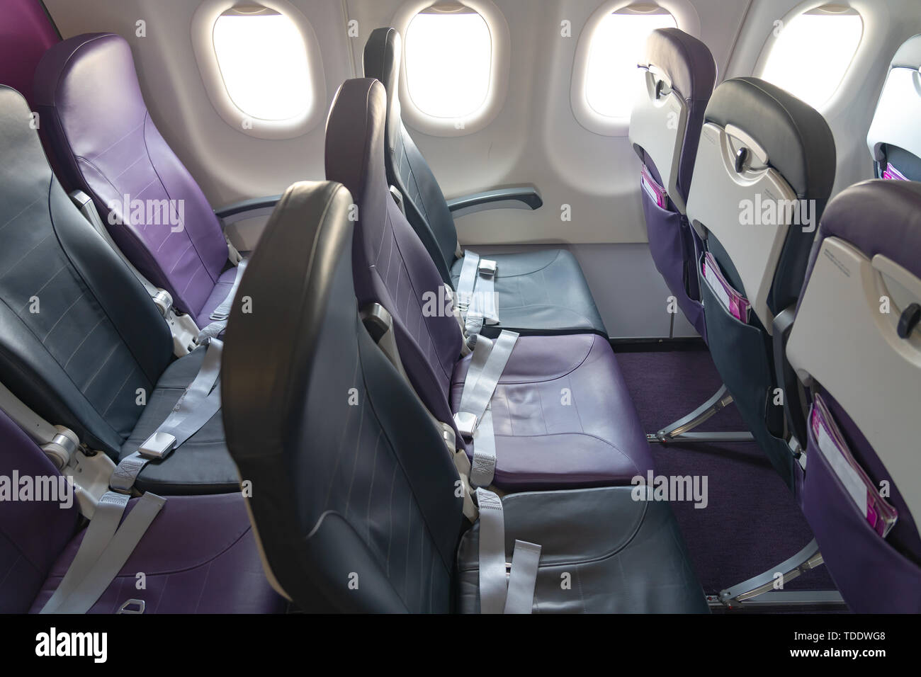 Airplane seats in the cabin economy class and the windows of the ...