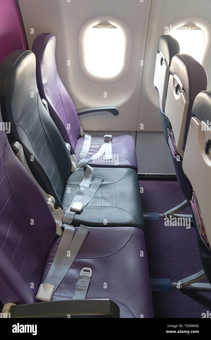 Airplane seats in the cabin economy class and the windows of the ...