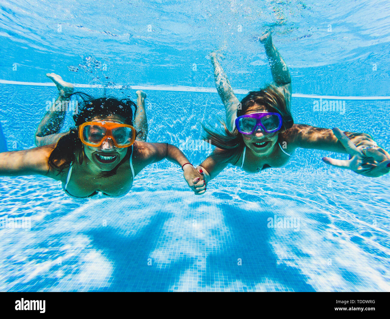 Friends swimming underwater together hi-res stock photography and ...