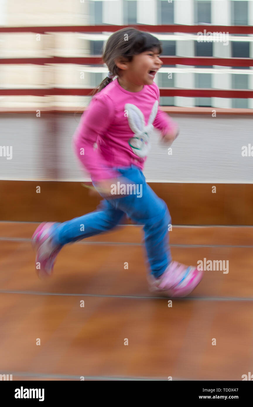 Children doing panning photo technique running Stock Photo - Alamy