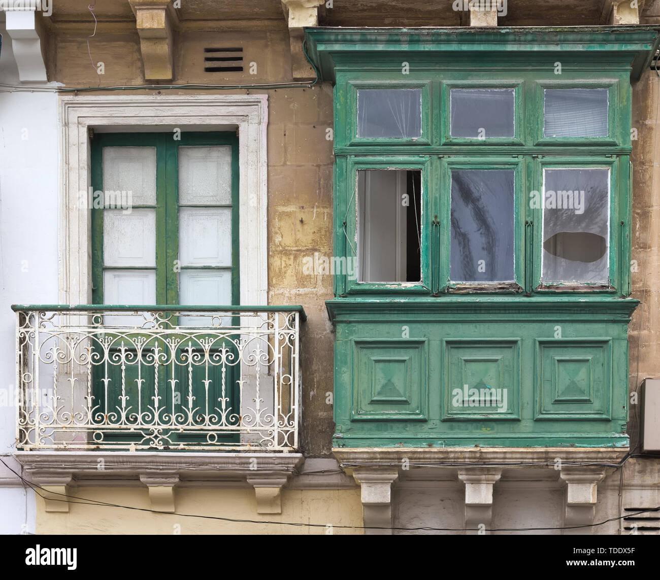 Typical Maltese covered green balcony and windows Stock Photo - Alamy