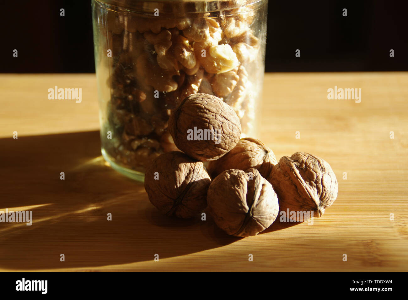 Walnuts on wooden board. Nuts in the shell on wood. Natural and healthy ...