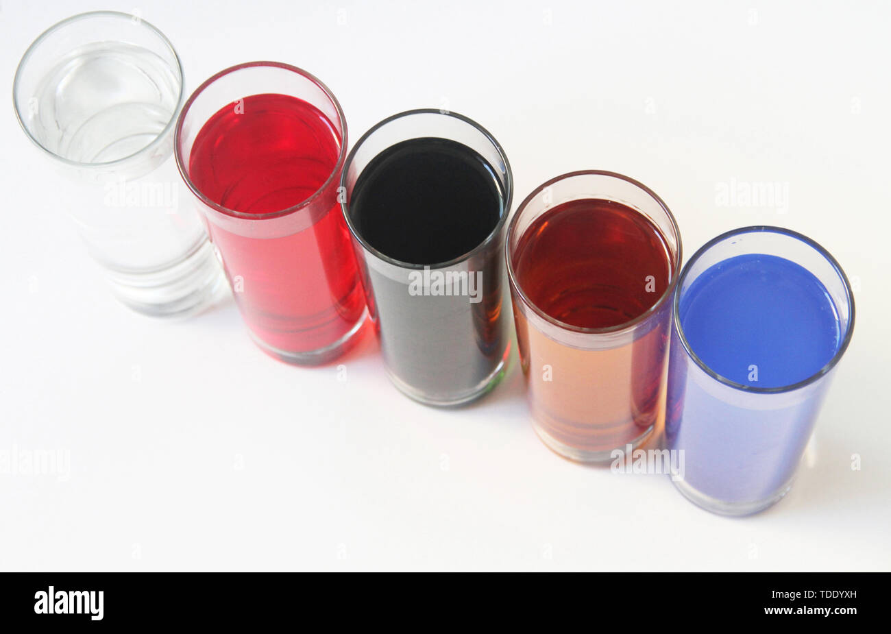 Five Glasses of multicoloured liquid on white background, São Paulo ...