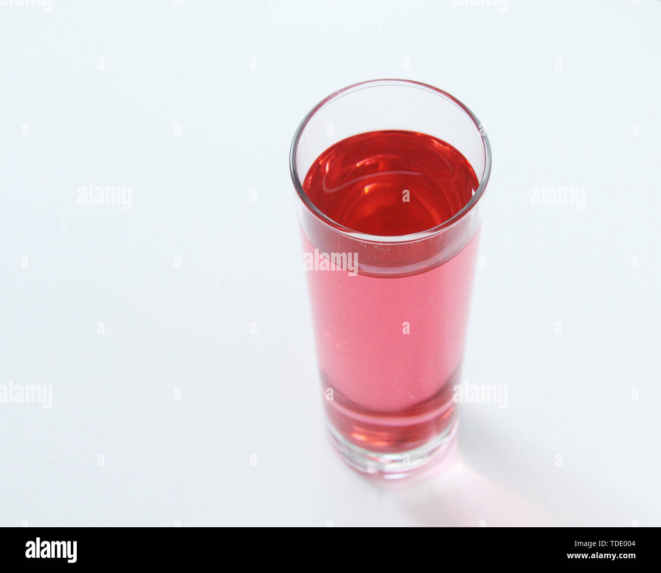 Glass of rose liquid on white background, São Paulo, Brazil Stock Photo ...