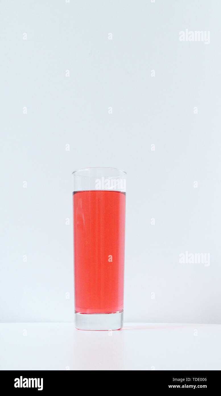 Glass of red liquid on white background, São Paulo, Brazil Stock Photo ...