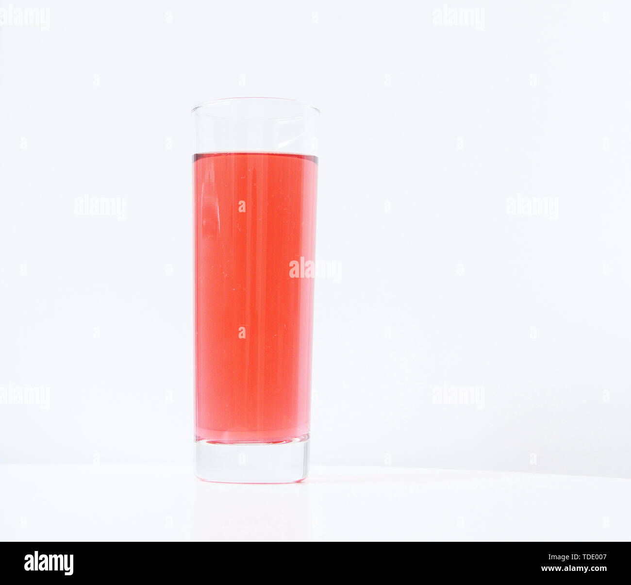 Glass of red liquid on white background, São Paulo, Brazil Stock Photo ...