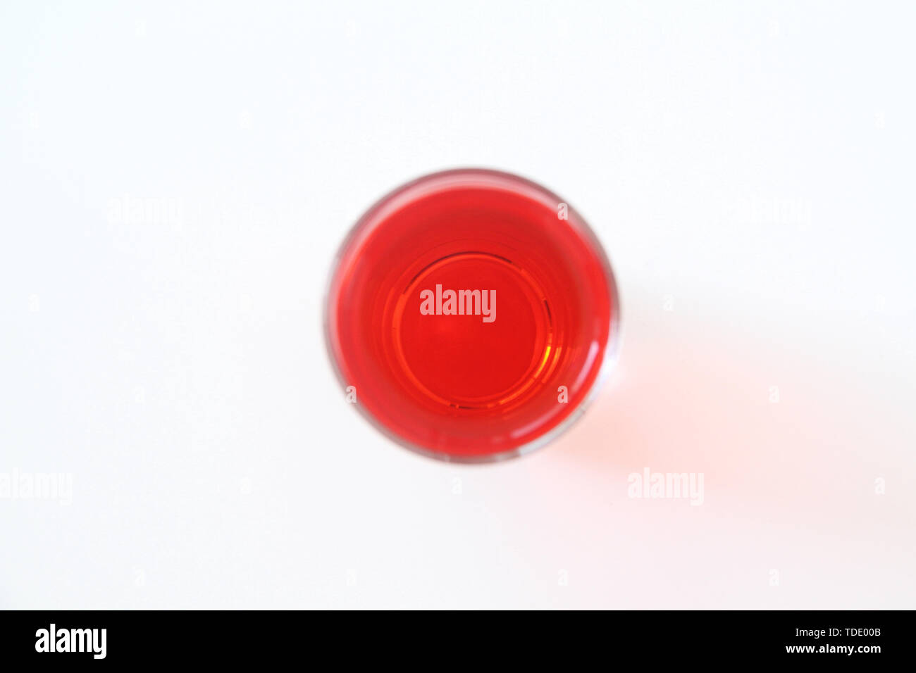 Glass of red liquid on white background, São Paulo, Brazil Stock Photo ...