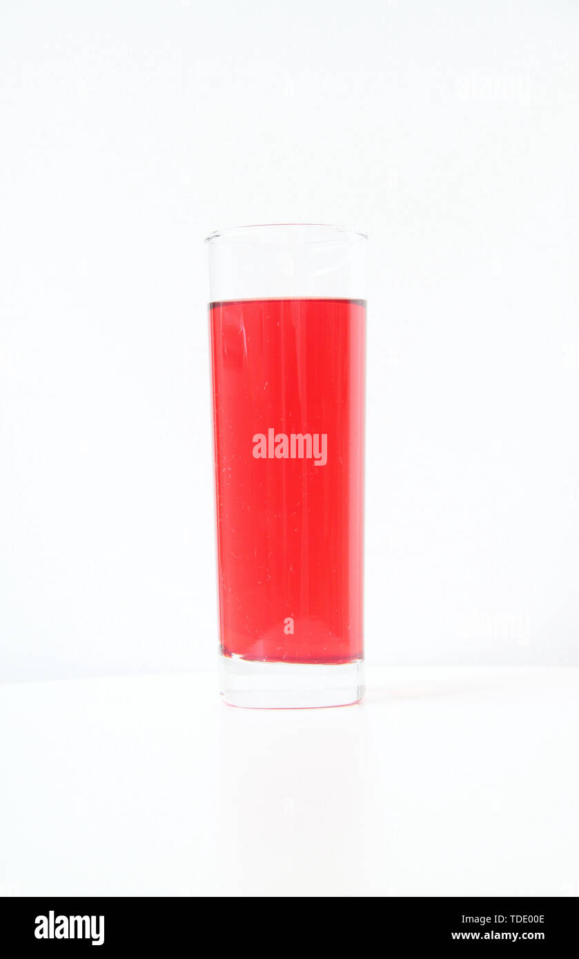 Glass of red liquid on white background, São Paulo, Brazil Stock Photo ...