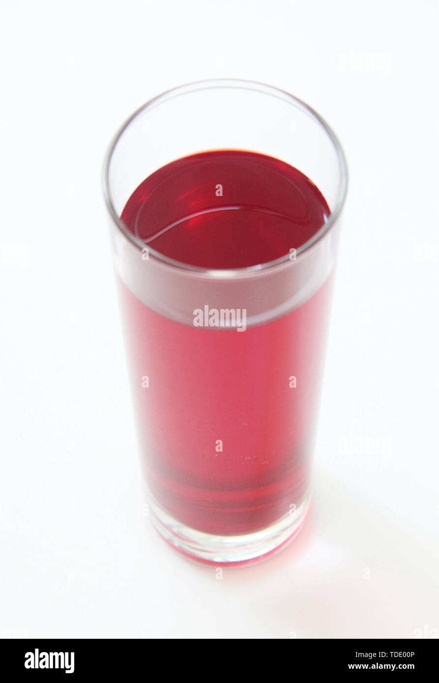 Glass of red liquid on white background, São Paulo, Brazil Stock Photo ...