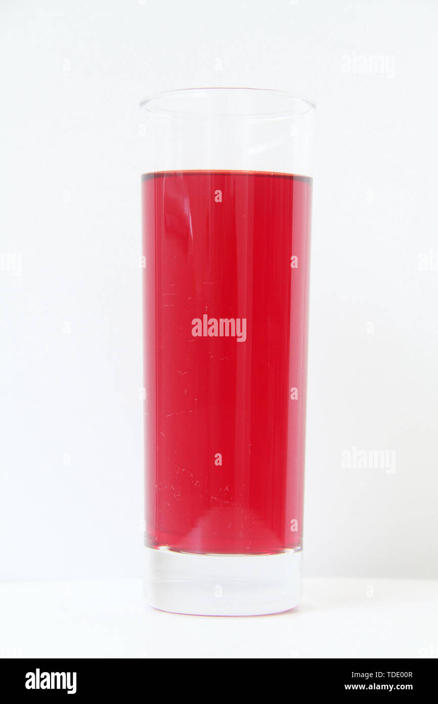 Glass of red liquid on white background, São Paulo, Brazil Stock Photo ...