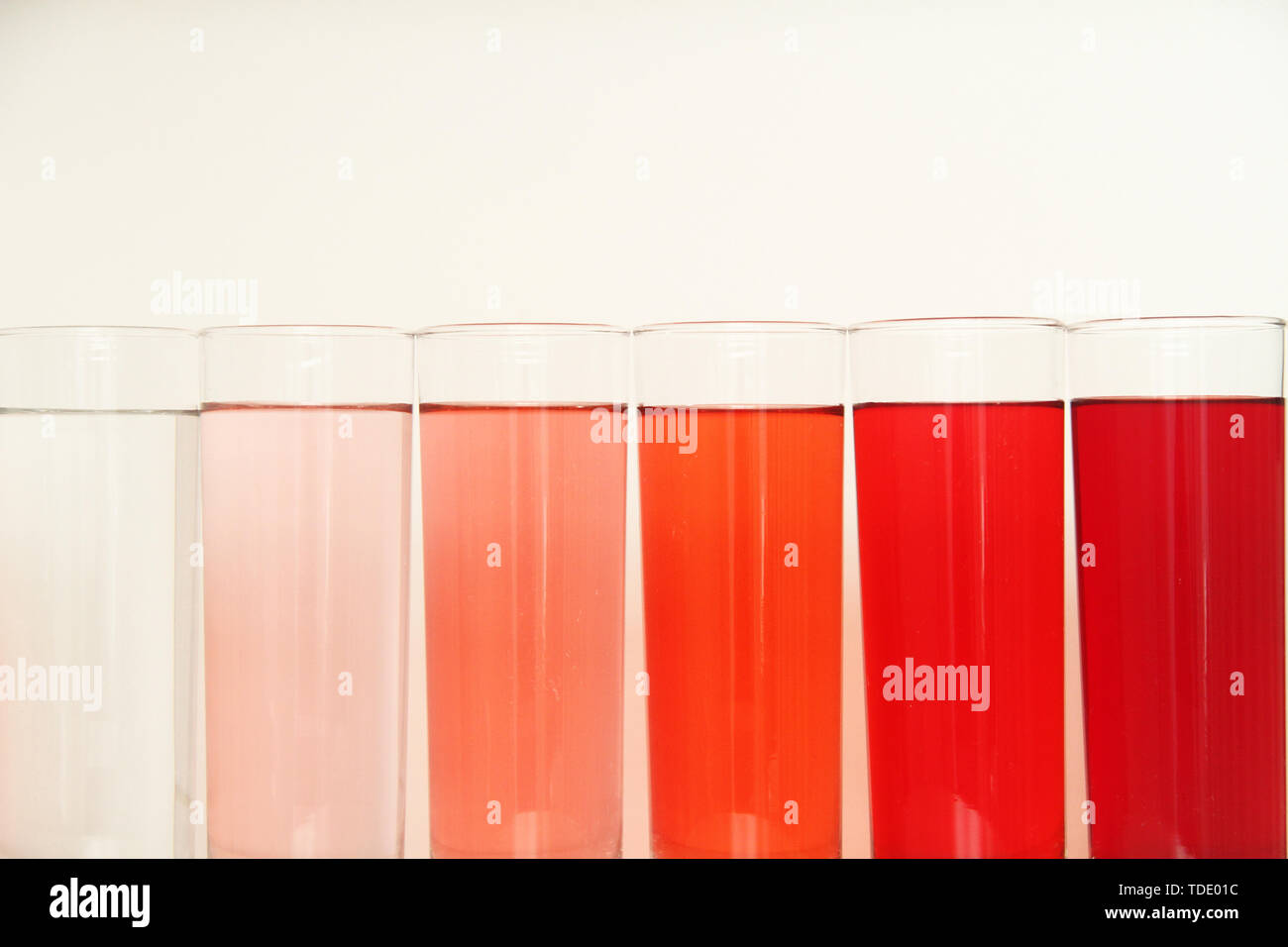 Five glasses of red liquid on white background, São Paulo, Brazil Stock ...