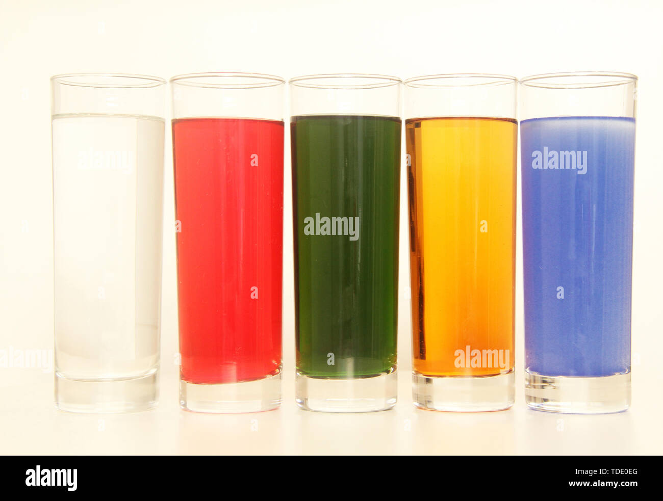 Five Glasses of multicoloured liquid on white background, São Paulo ...