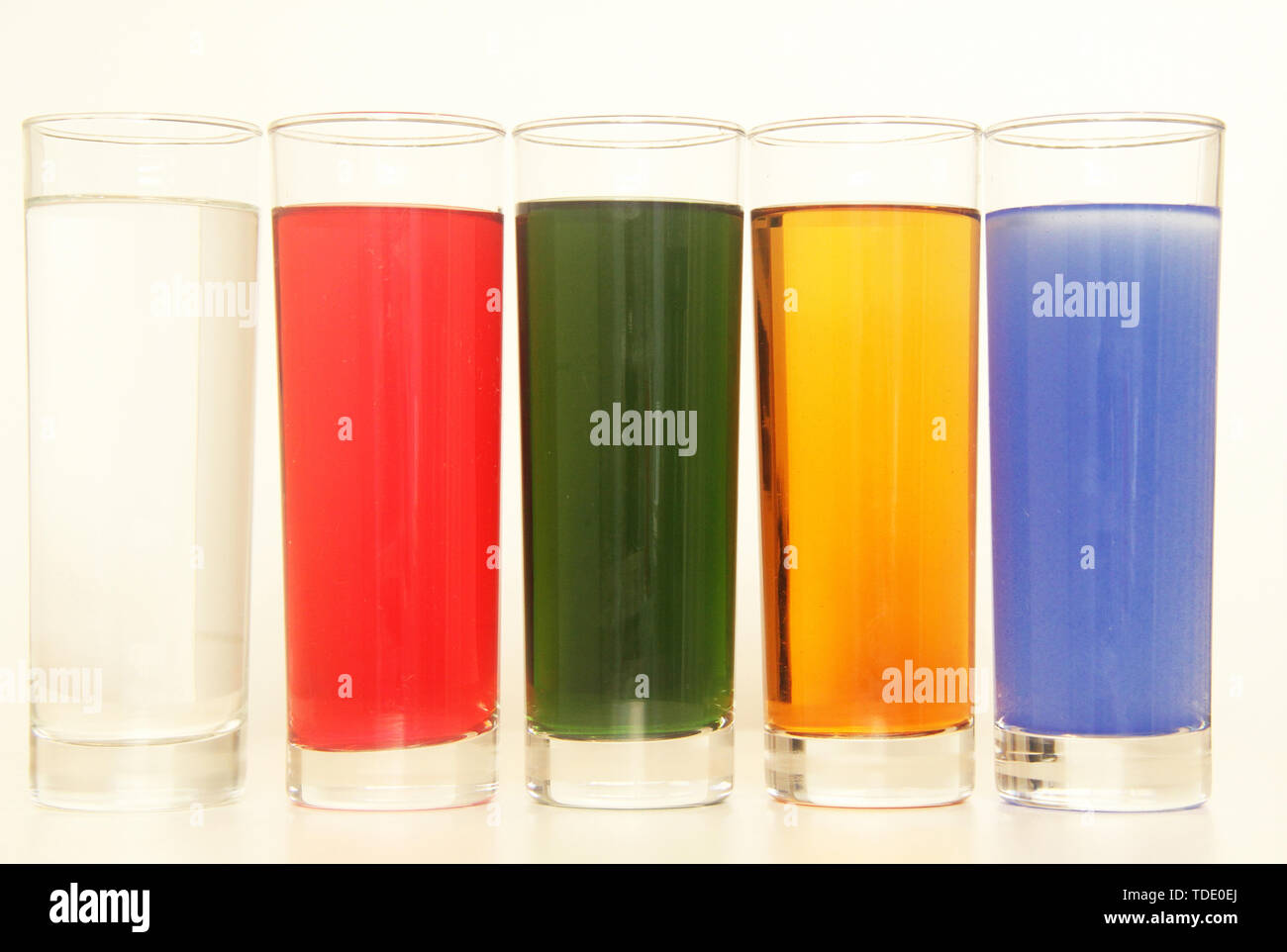 Five Glasses of multicoloured liquid on white background, São Paulo ...