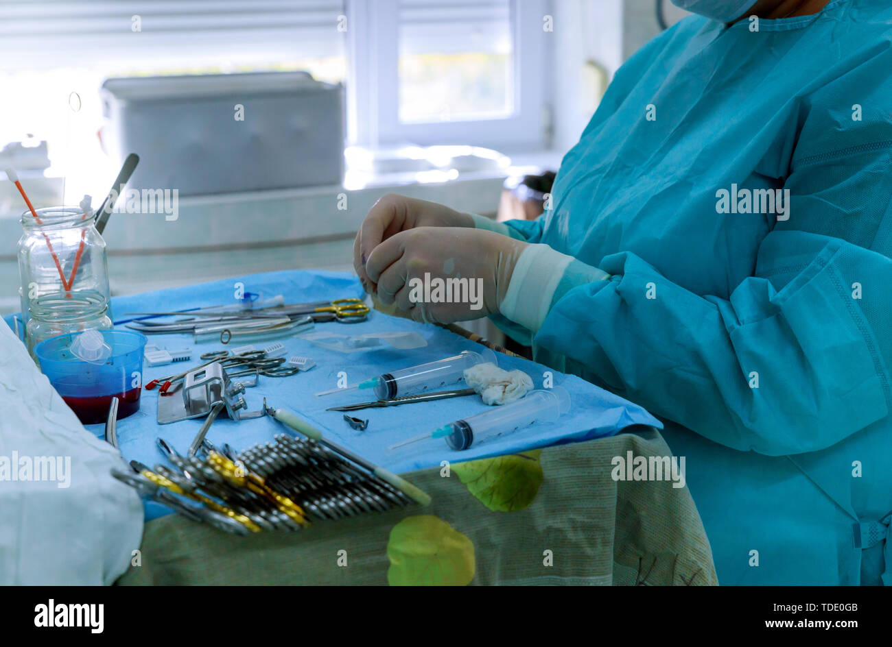 Operating room nurse preparing medical instruments tray with medical ...