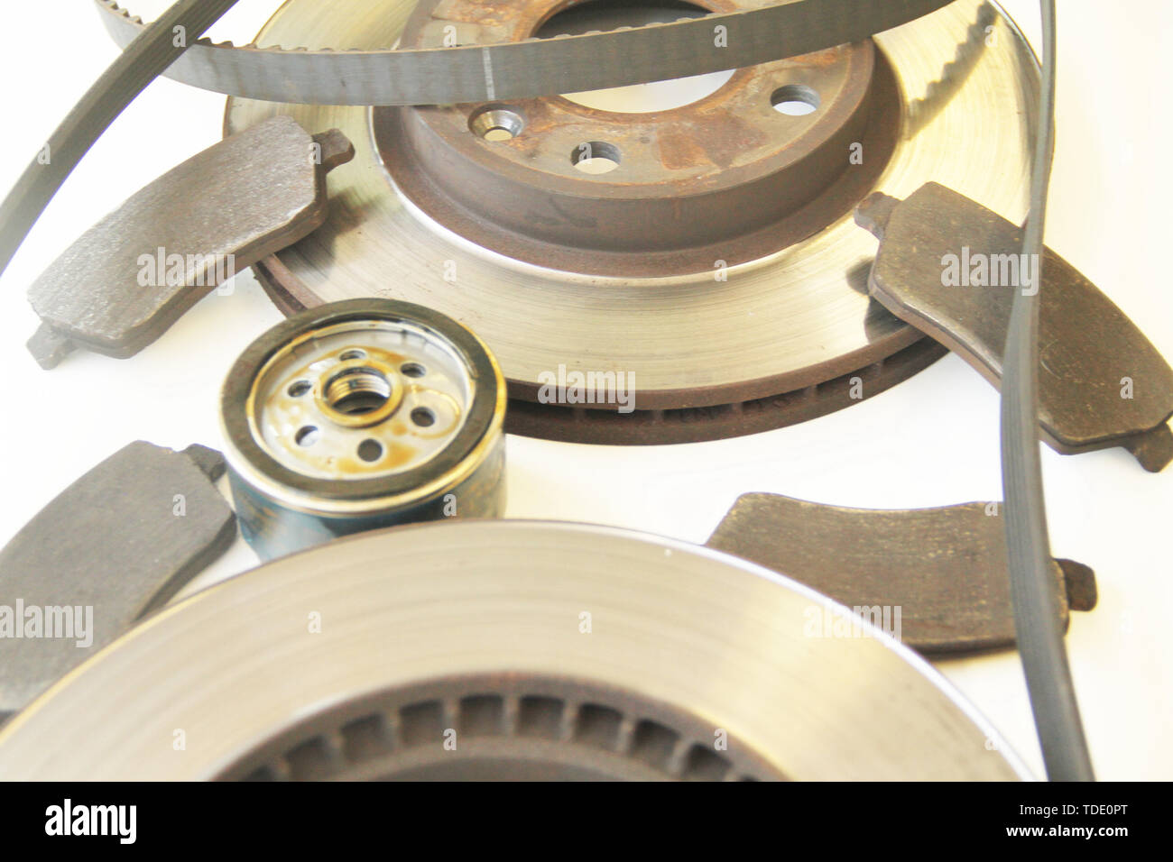 Pair old car brake disc, pads, oil filter and belt isolated on white ...