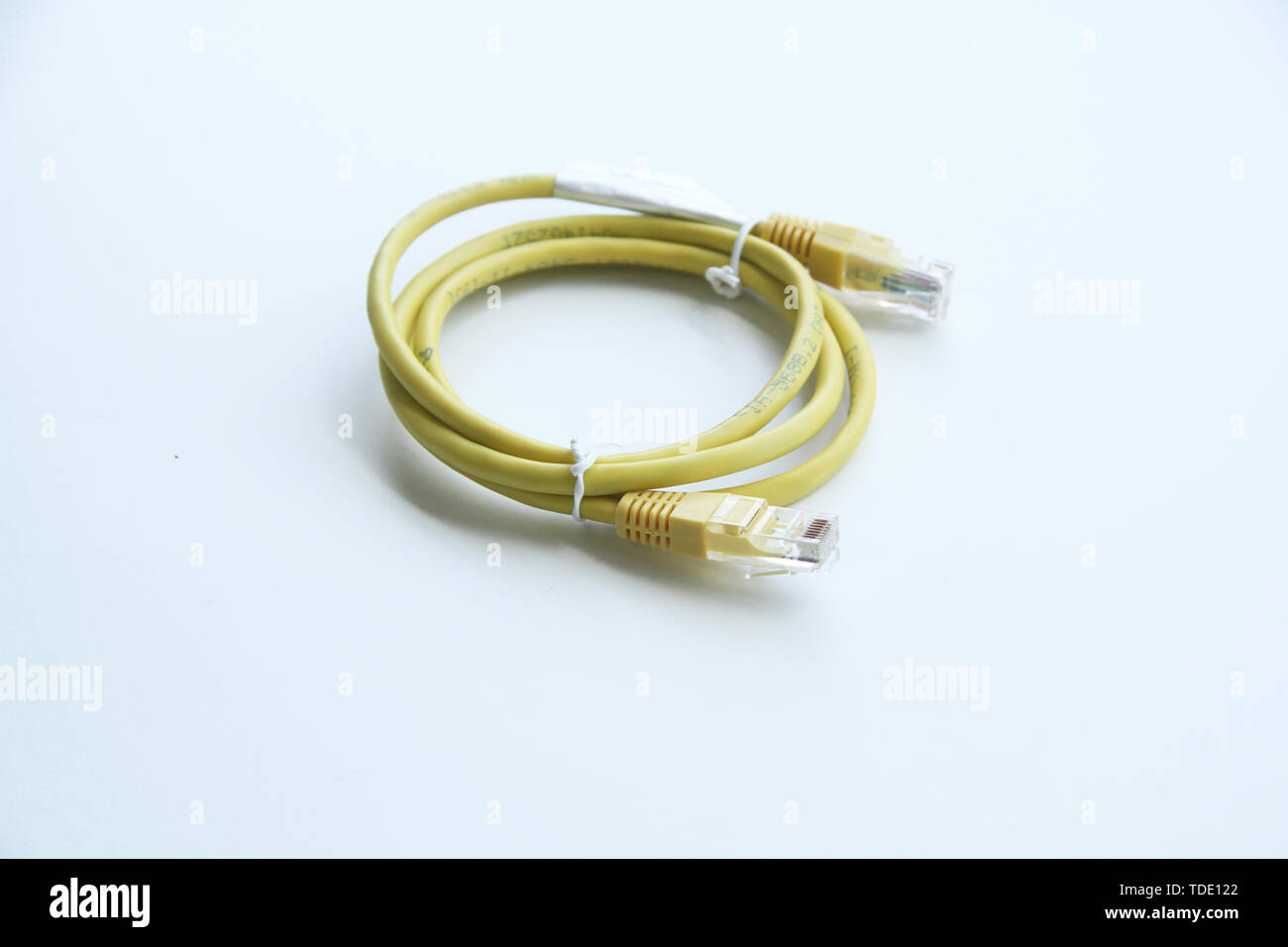 Yellow rolled-up patch cable, used to connect a computer to an internal ...