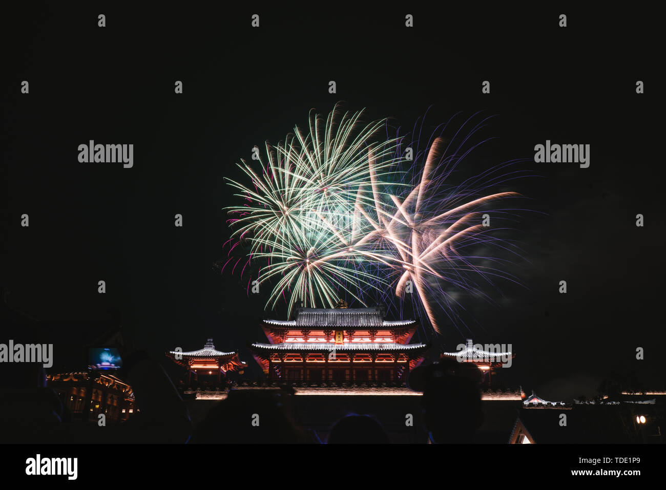 Fireworks blooming above Chinese ancient buildings Stock Photo - Alamy
