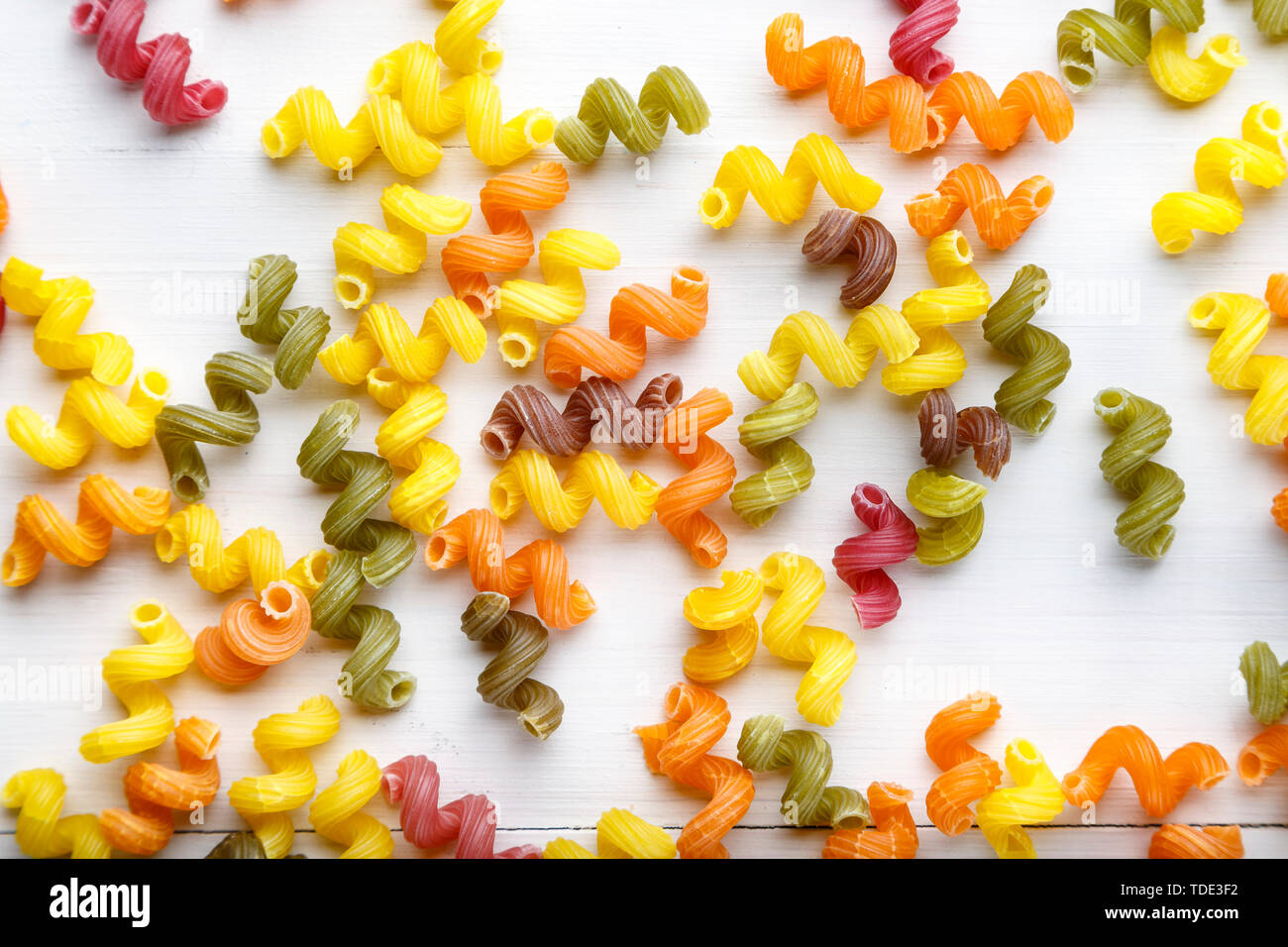 Multicolored Cellentani pasta. Italian traditions in food. Top view ...