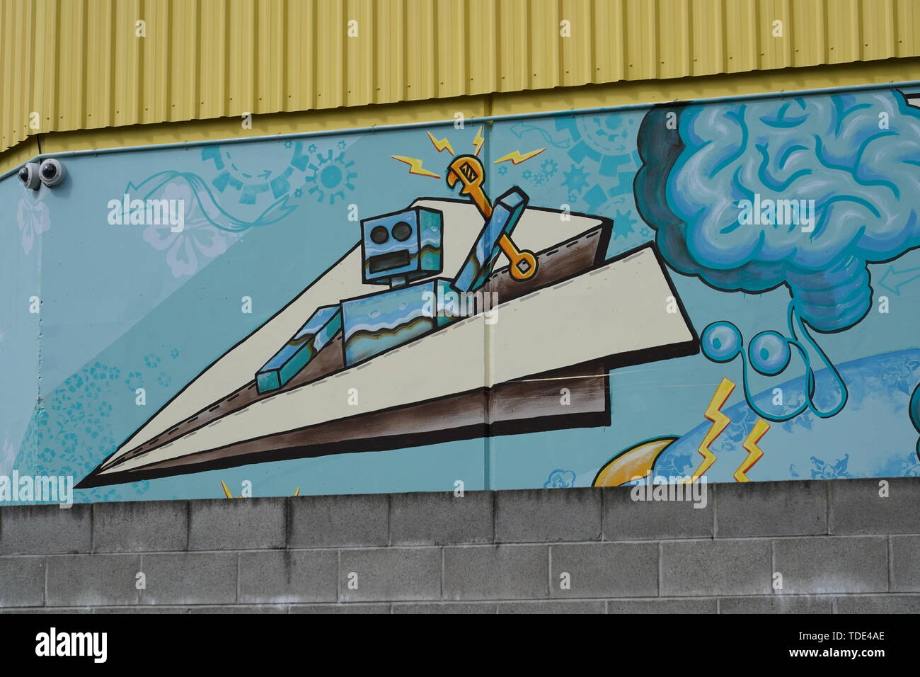 Robot flying a paper airplane with a key Stock Photo - Alamy