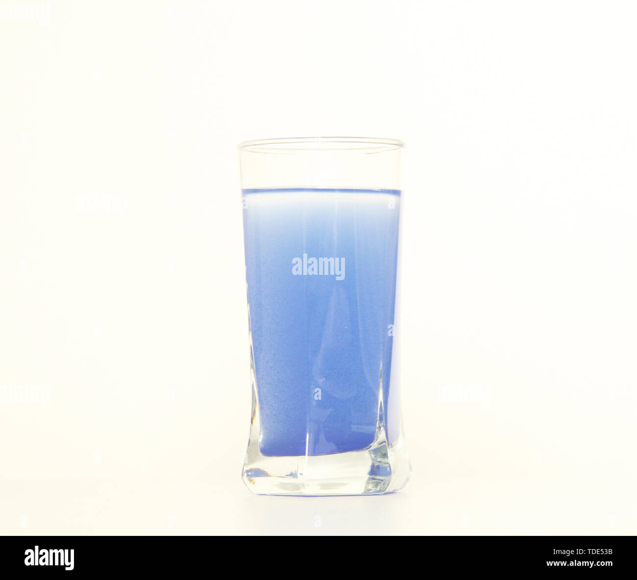 Glass of blue liquid on white background, São Paulo, Brazil Stock Photo ...