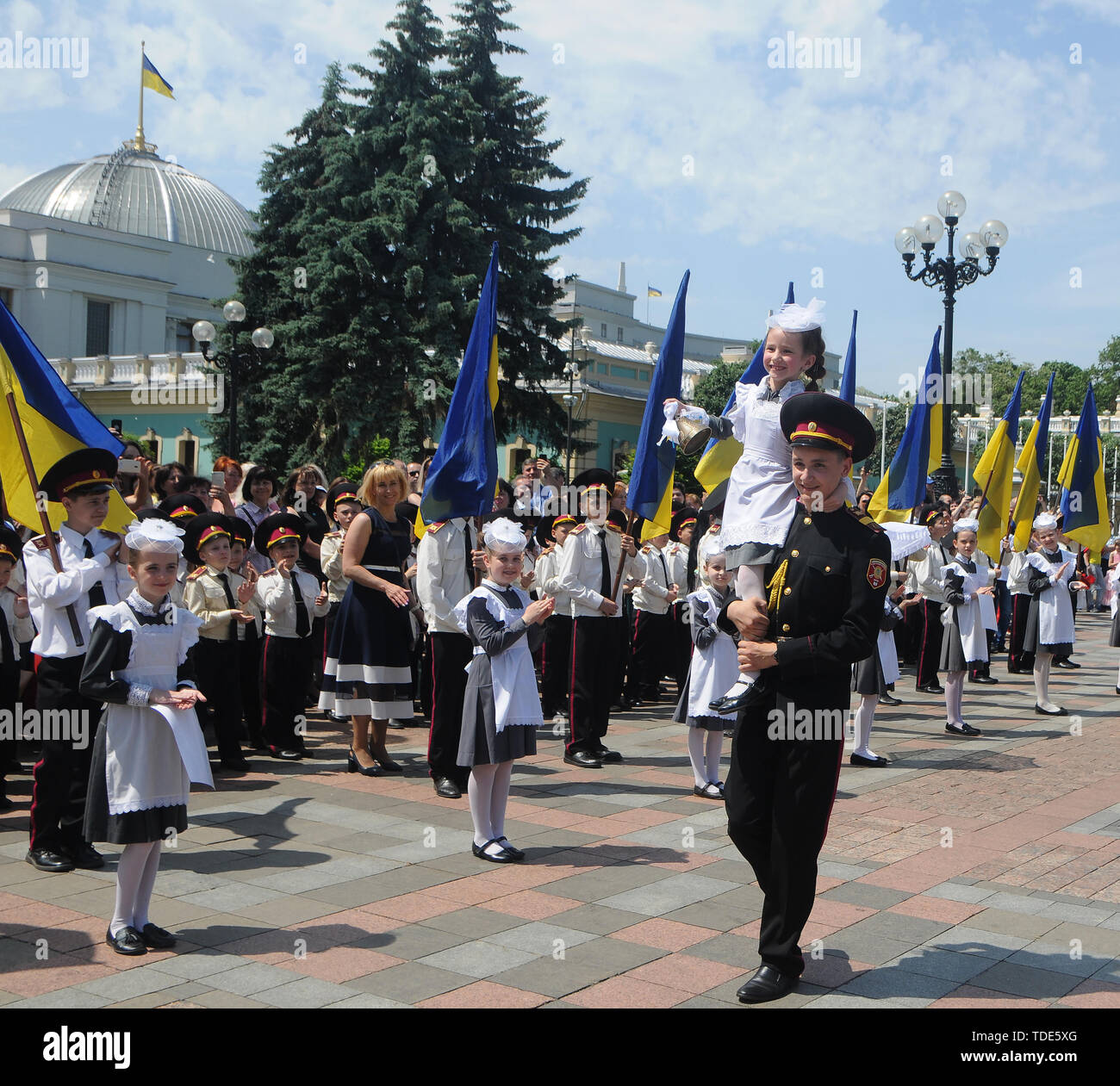 A cadet caries a pupil of an elementary school during the ceremony ...