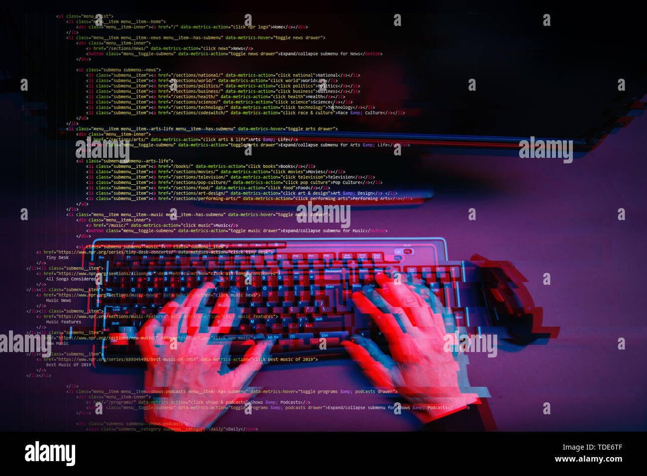 Hacker working with computer in dark room with digital interface around ...