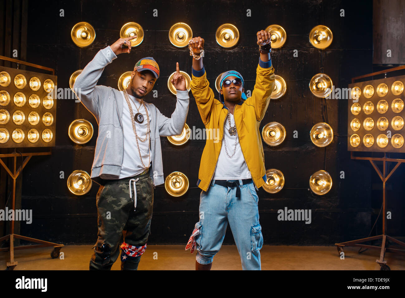 Two black rappers in caps, perfomance on stage Stock Photo - Alamy