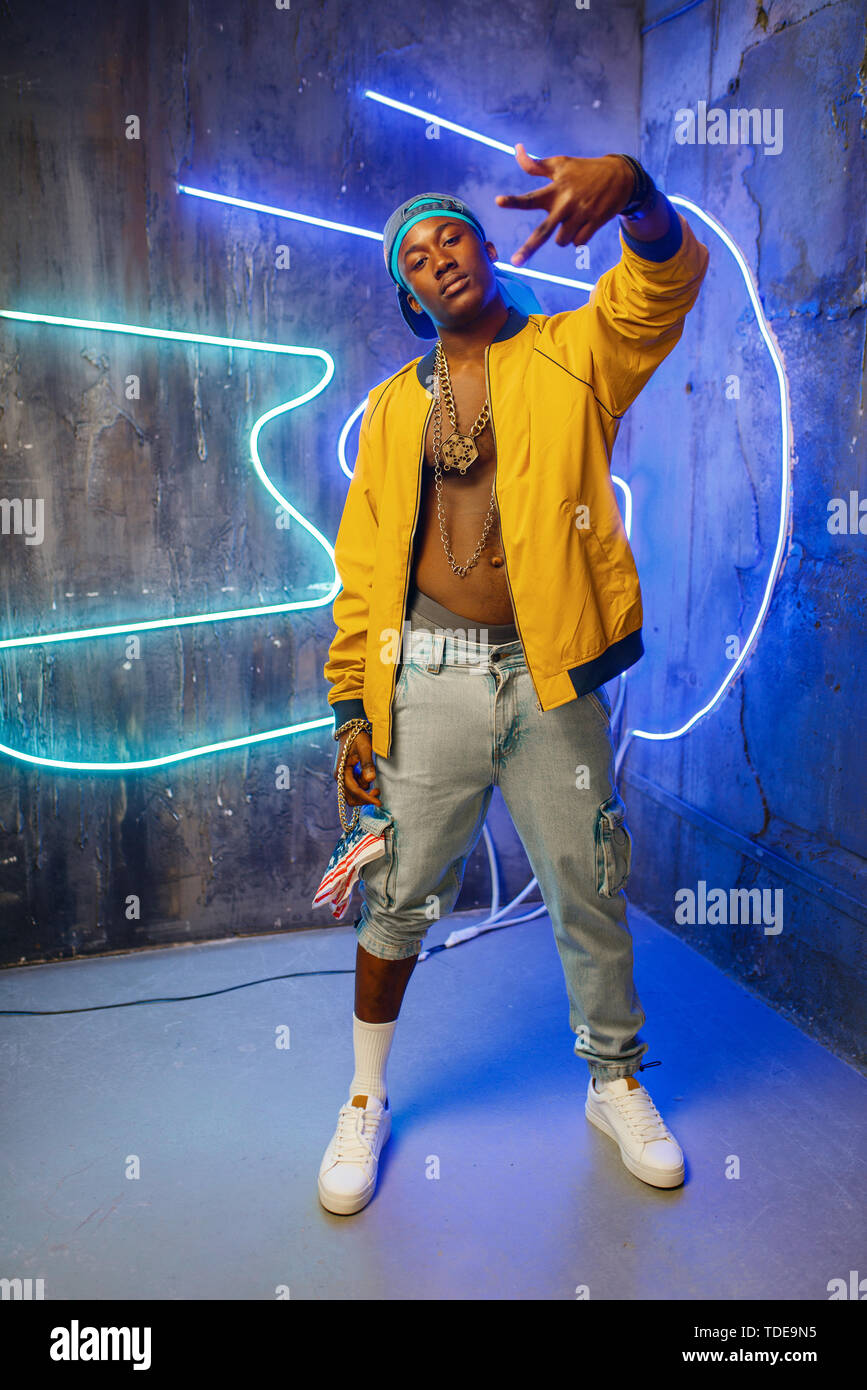 Black rapper in underpass neon light on background Stock Photo - Alamy