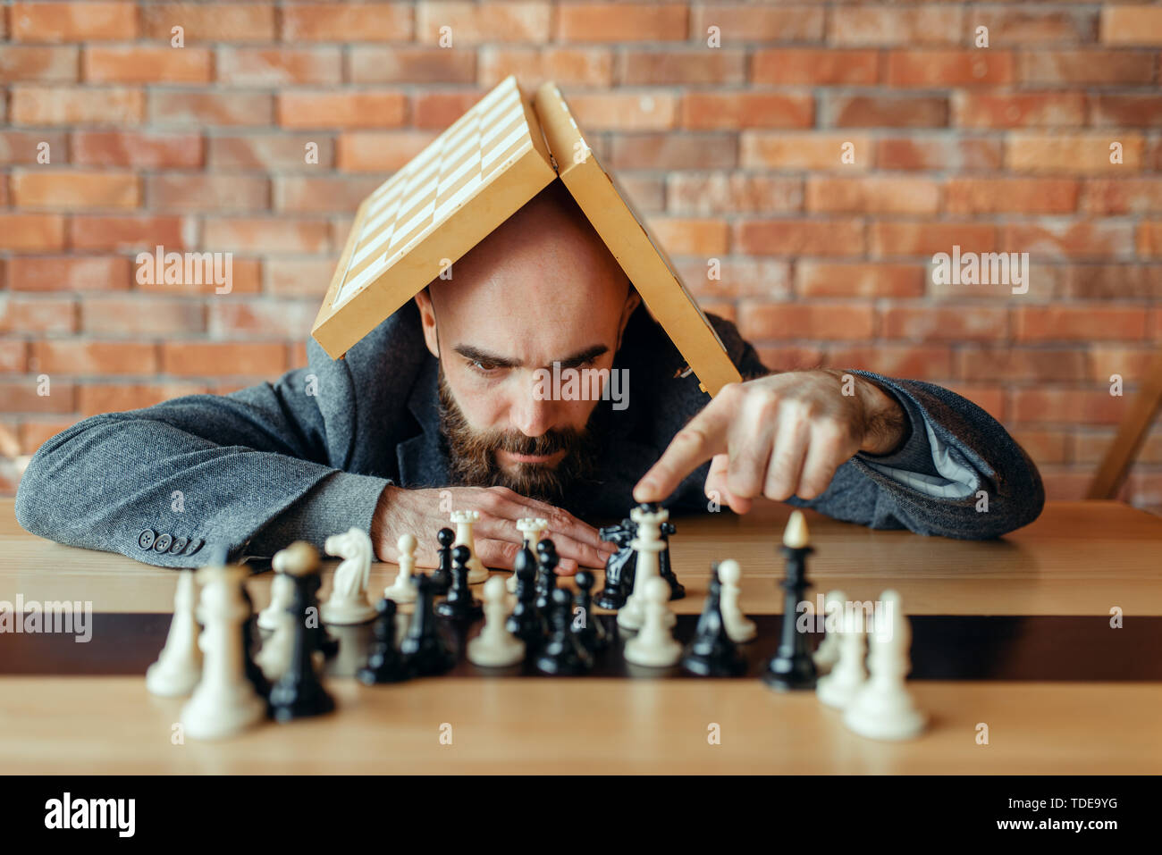 Male chess player with board on his head Stock Photo - Alamy
