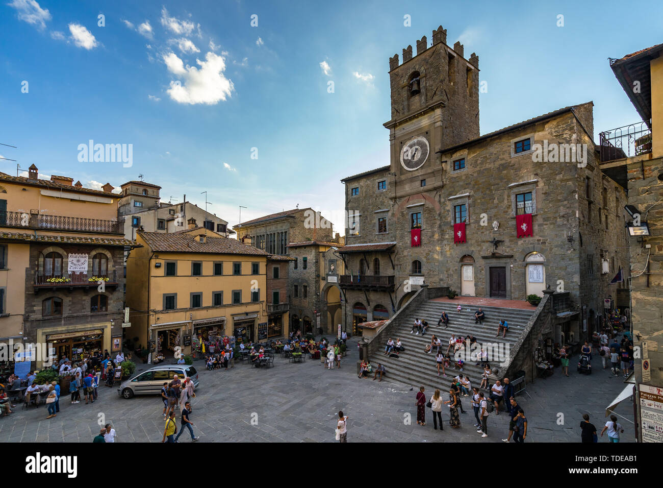 The lively medieval center of Cortona with the imposing city hall ...