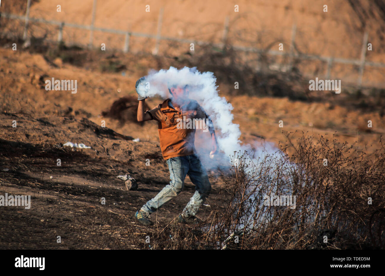 Gaza, Palestine. 14th June, 2019. A Palestinian protester throws a tear ...