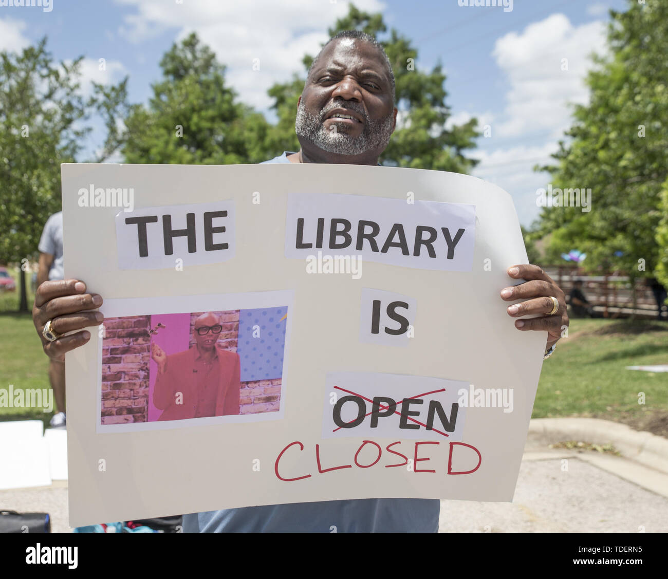 Leander, TX, USA. 15th June, 2019. A protester holds a sign outside the ...