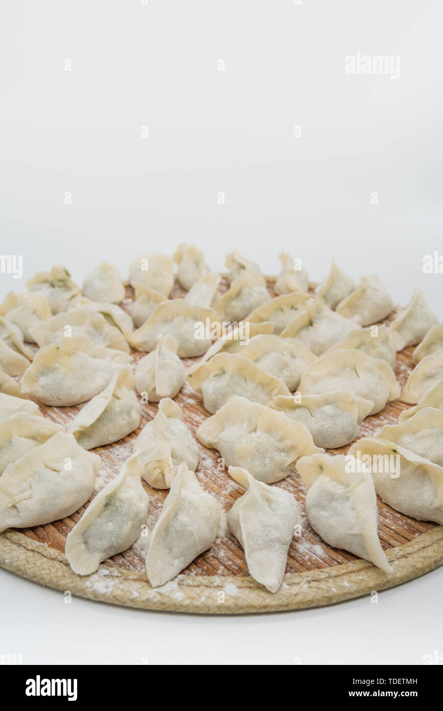 A close-up of freshly wrapped raw dumplings Stock Photo - Alamy