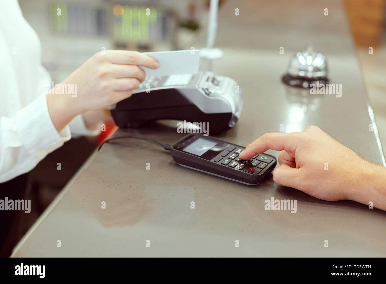 Guest at hotel reception paying with check during check-in Stock Photo ...