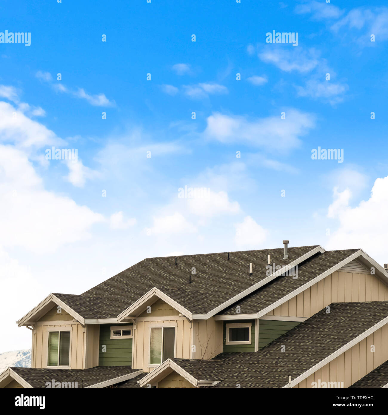 Square House exterior with view of the dark pitched roof against a ...