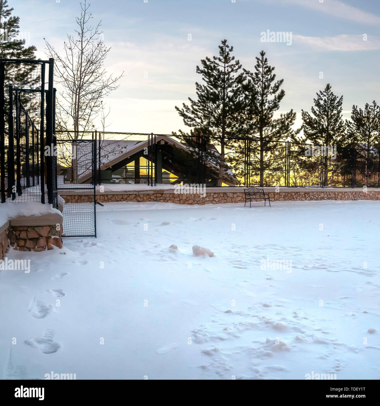 Square Area enclosed in a chain link fence and civered with fresh snow ...