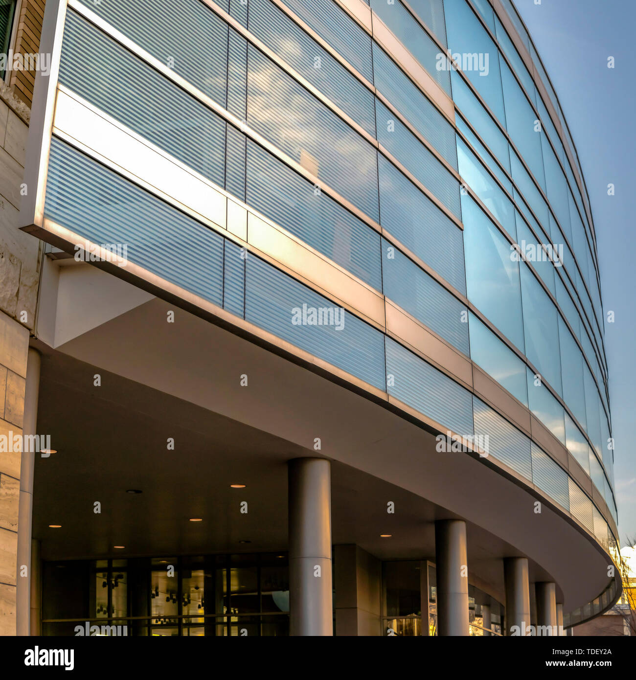 Square Exterior of a modern building seen from below with blue sky ...