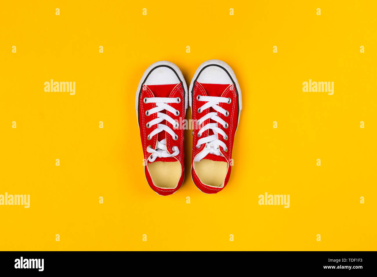 Red sneakers top view close up on colorful background Stock Photo - Alamy