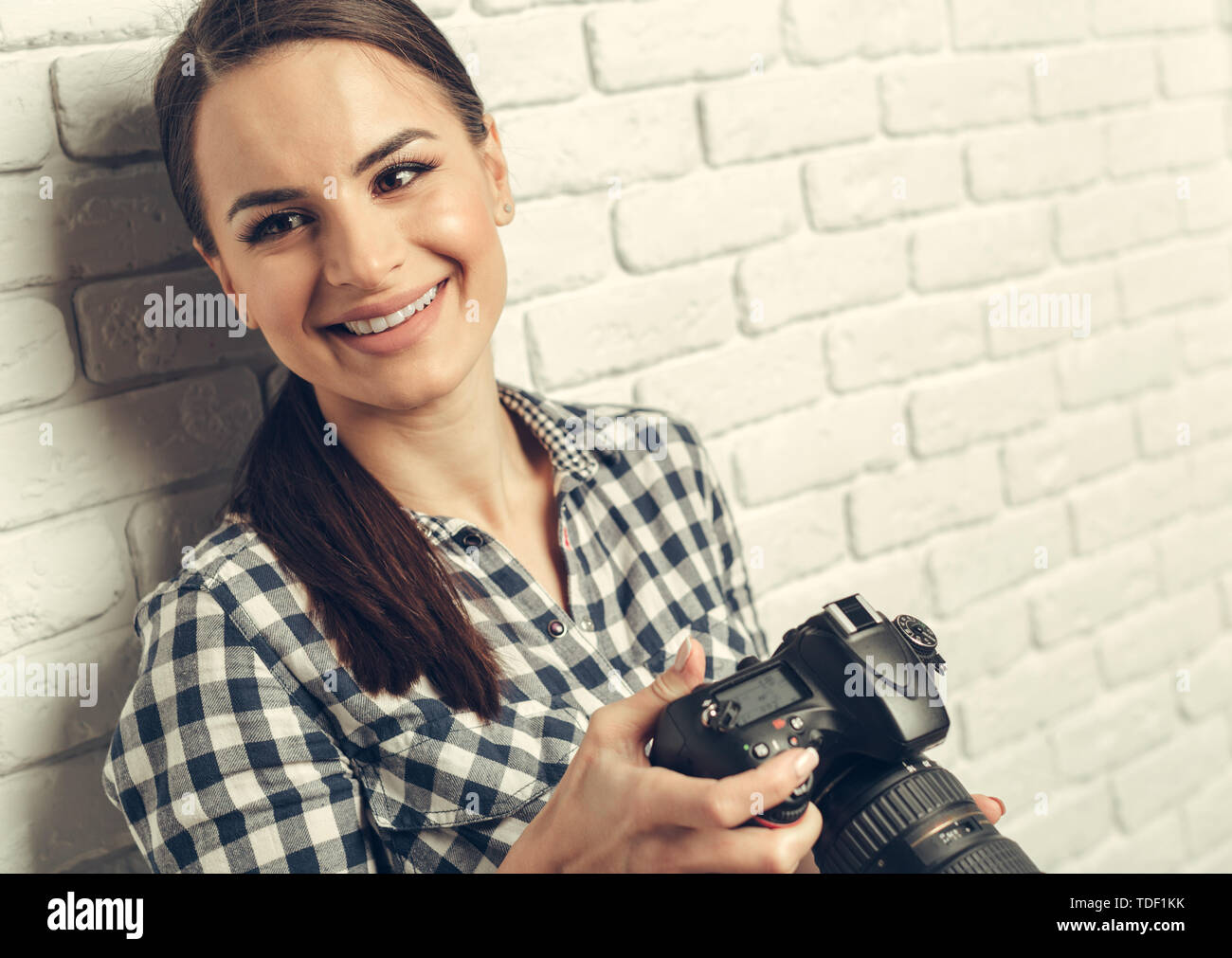 Pretty woman is a professional photographer with dslr camera Stock ...