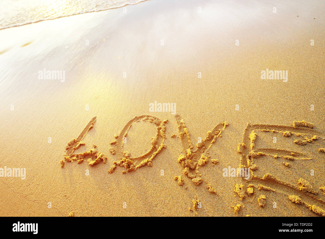 Love letters handwritten in sand on beach Stock Photo - Alamy