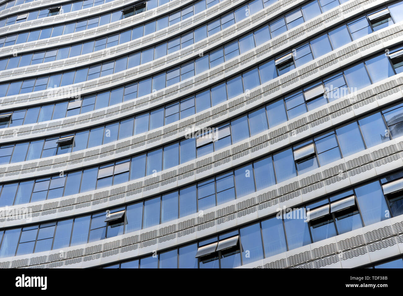 Modern office building with glass wall Stock Photo - Alamy